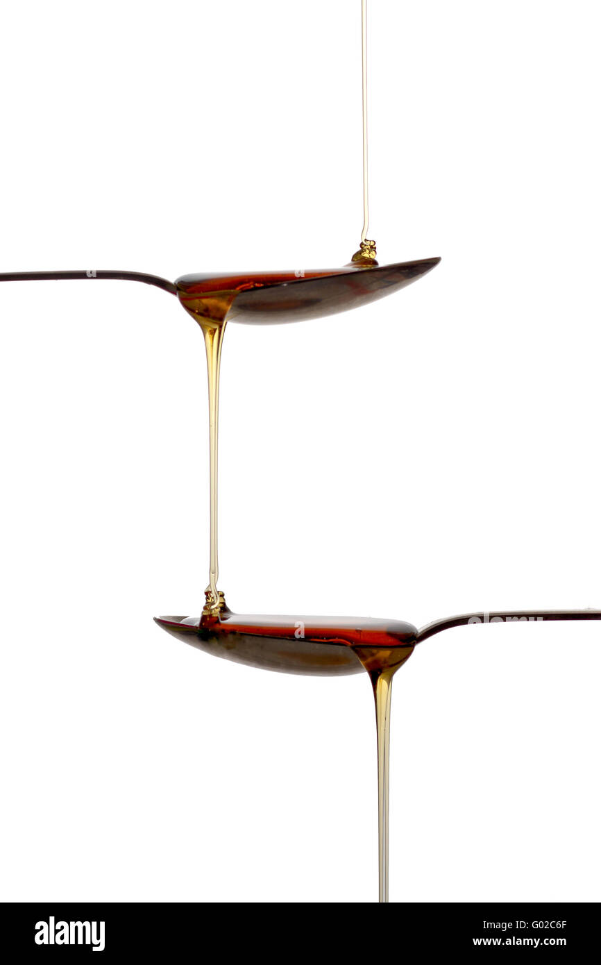 Spoons with syrup Stock Photo - Alamy
