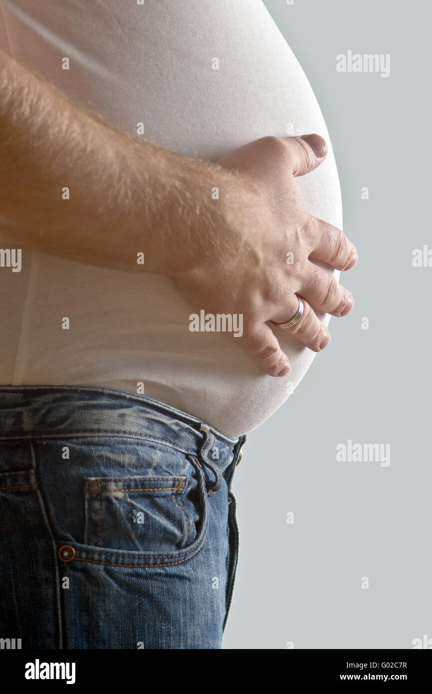 Overweight man with hand on belly Stock Photo - Alamy