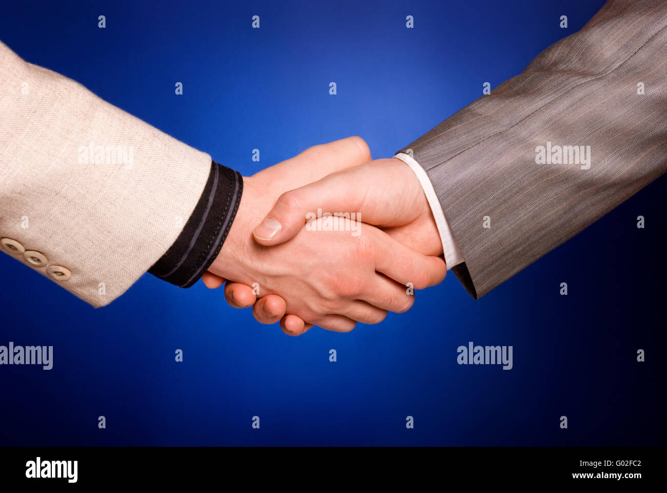 hand shake on blue Stock Photo - Alamy
