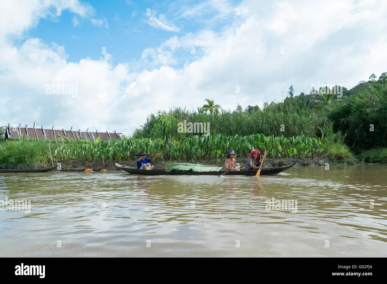 Family of Mentawai tribes crossing the river by traditional canoe Stock ...