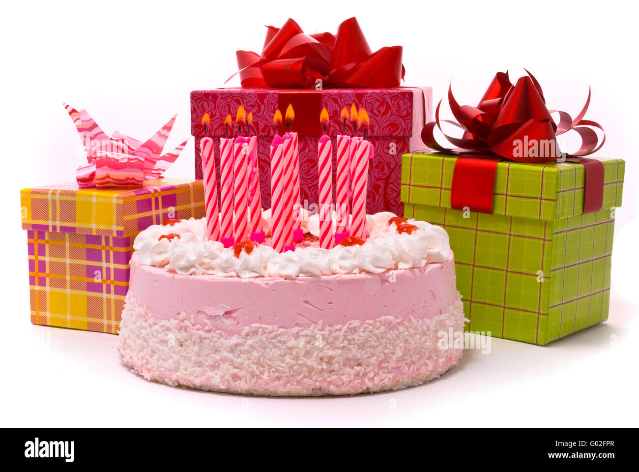 Pink pie with eleven candles and gifts in boxes on a white background ...