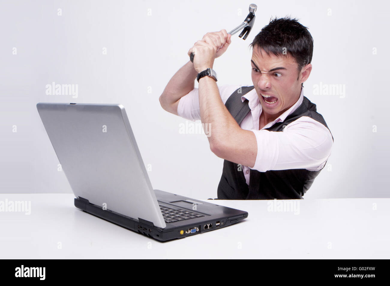 Brunette businessman looks at his computer in disbelief killing his ...