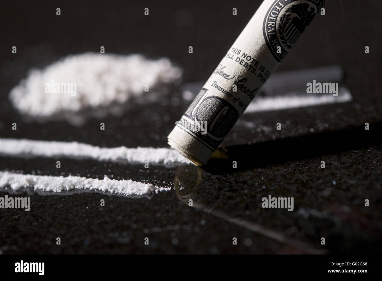 Lines of Cocaine with rolled $100 Stock Photo - Alamy