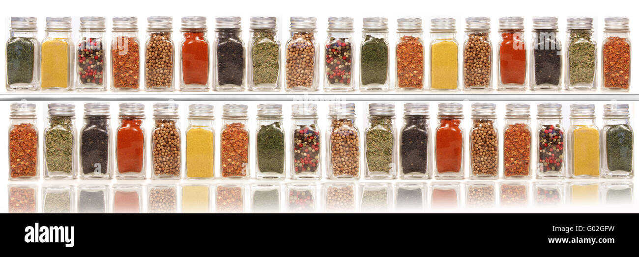 Assorted spices on two layer shelves against white Stock Photo - Alamy