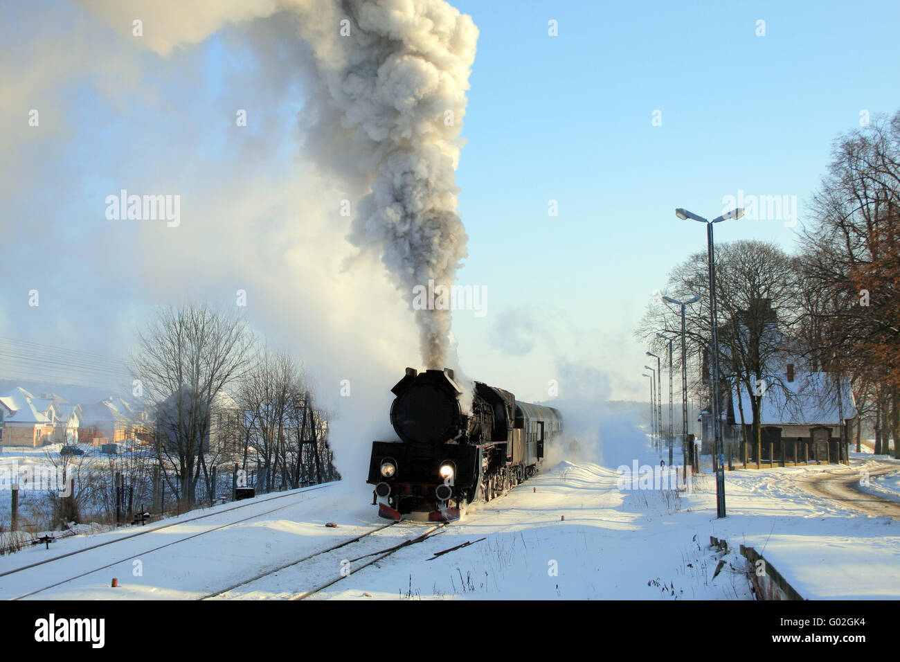 Vintage steam train starting from the station Stock Photo - Alamy
