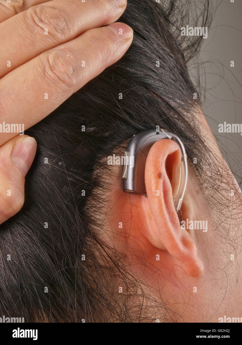 Woman wearing hearing aid Stock Photo - Alamy