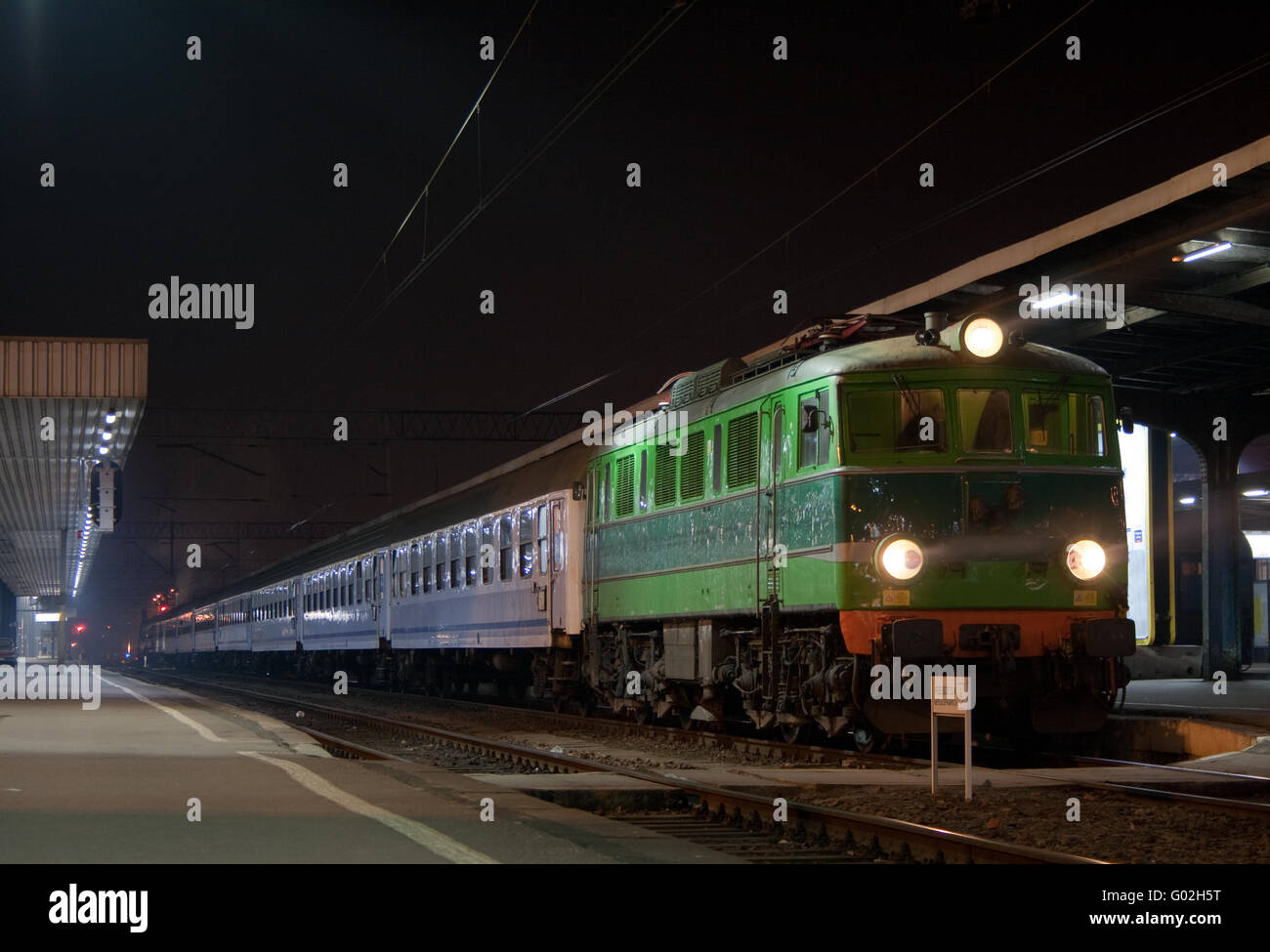 Passenger train waiting at the station platform during the night Stock ...
