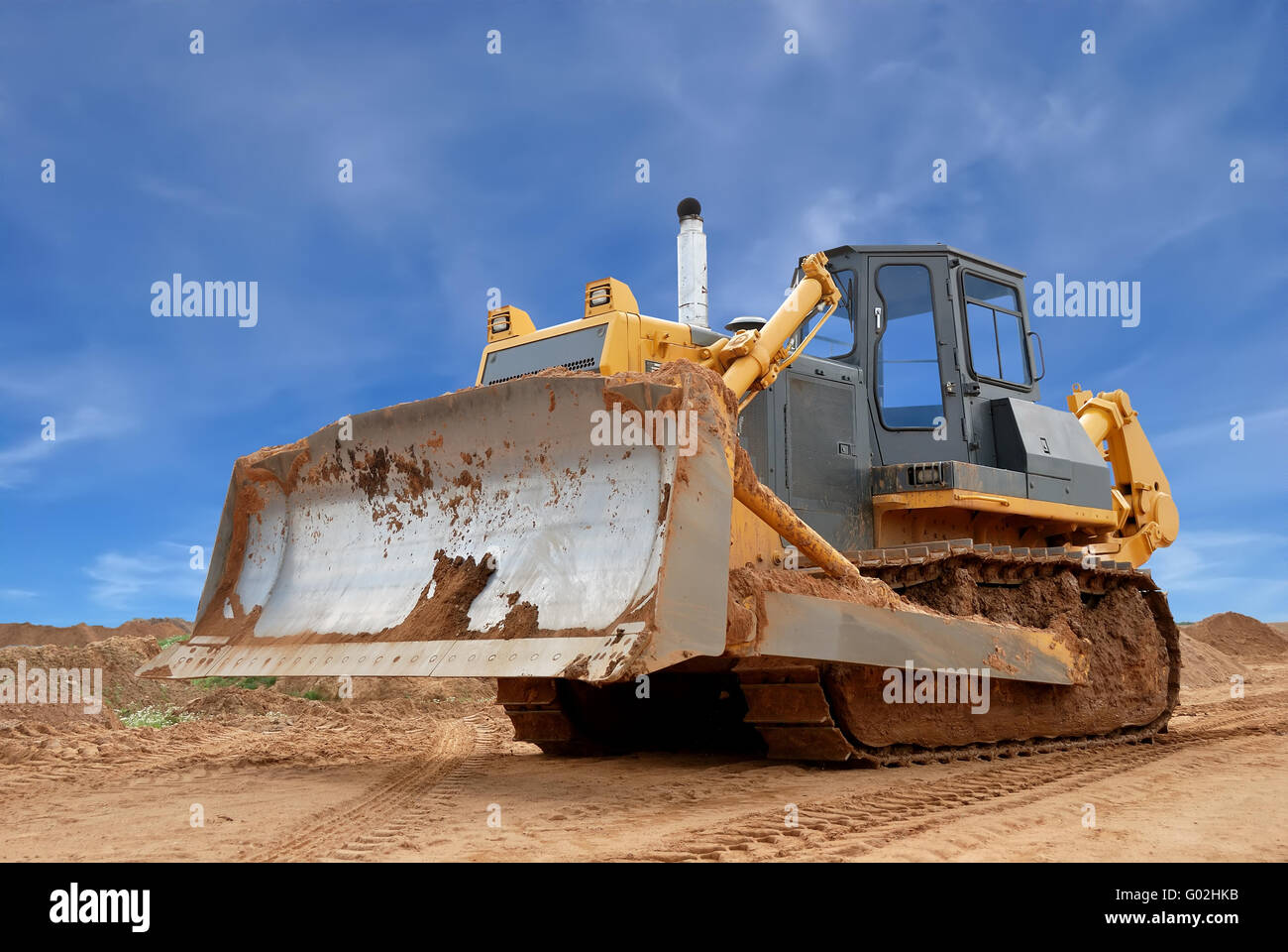 Heavy bulldozer with half raised blade in sandpit Stock Photo - Alamy