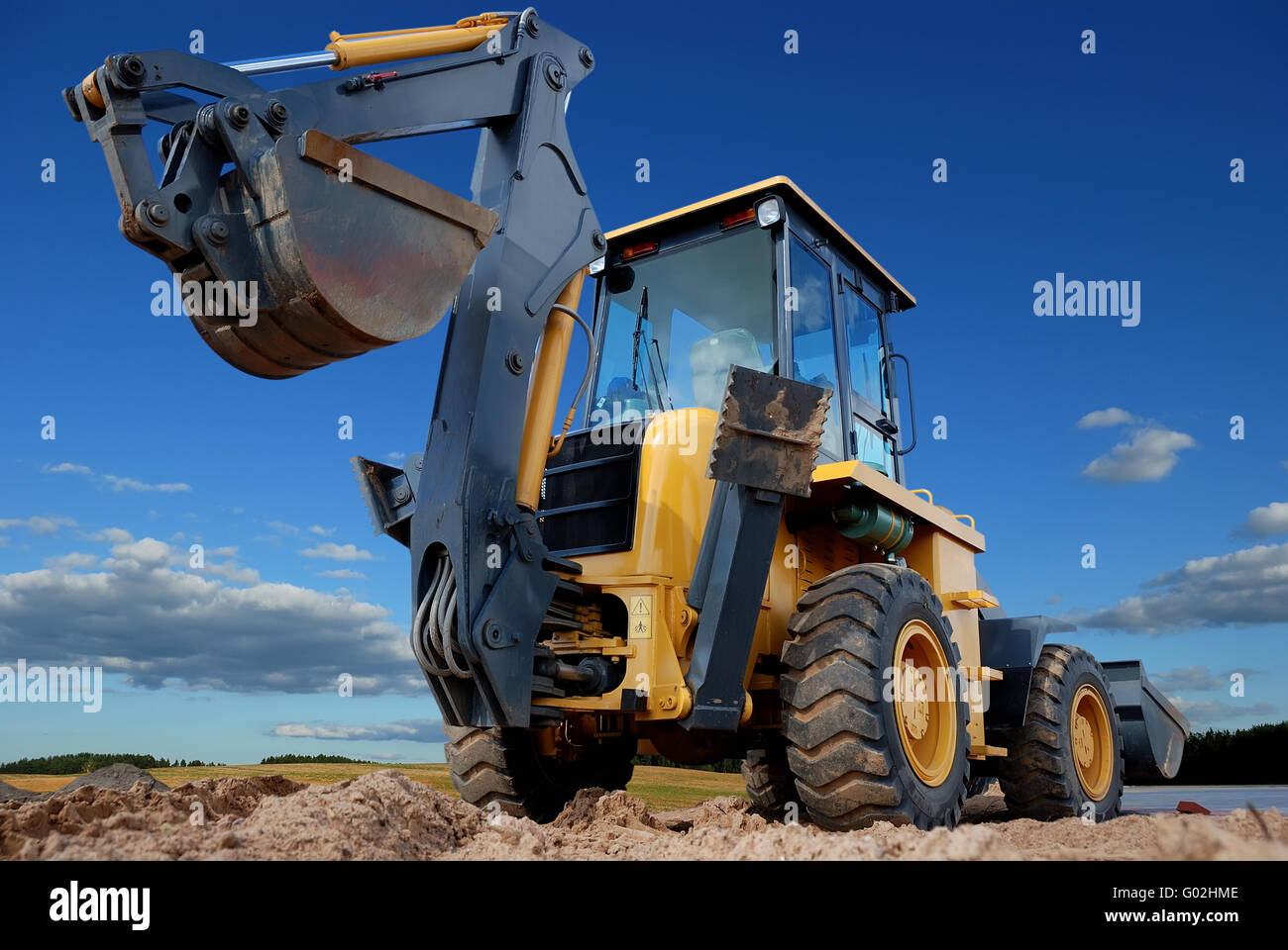 rear view of Loader excavator with rised backhoe Stock Photo - Alamy