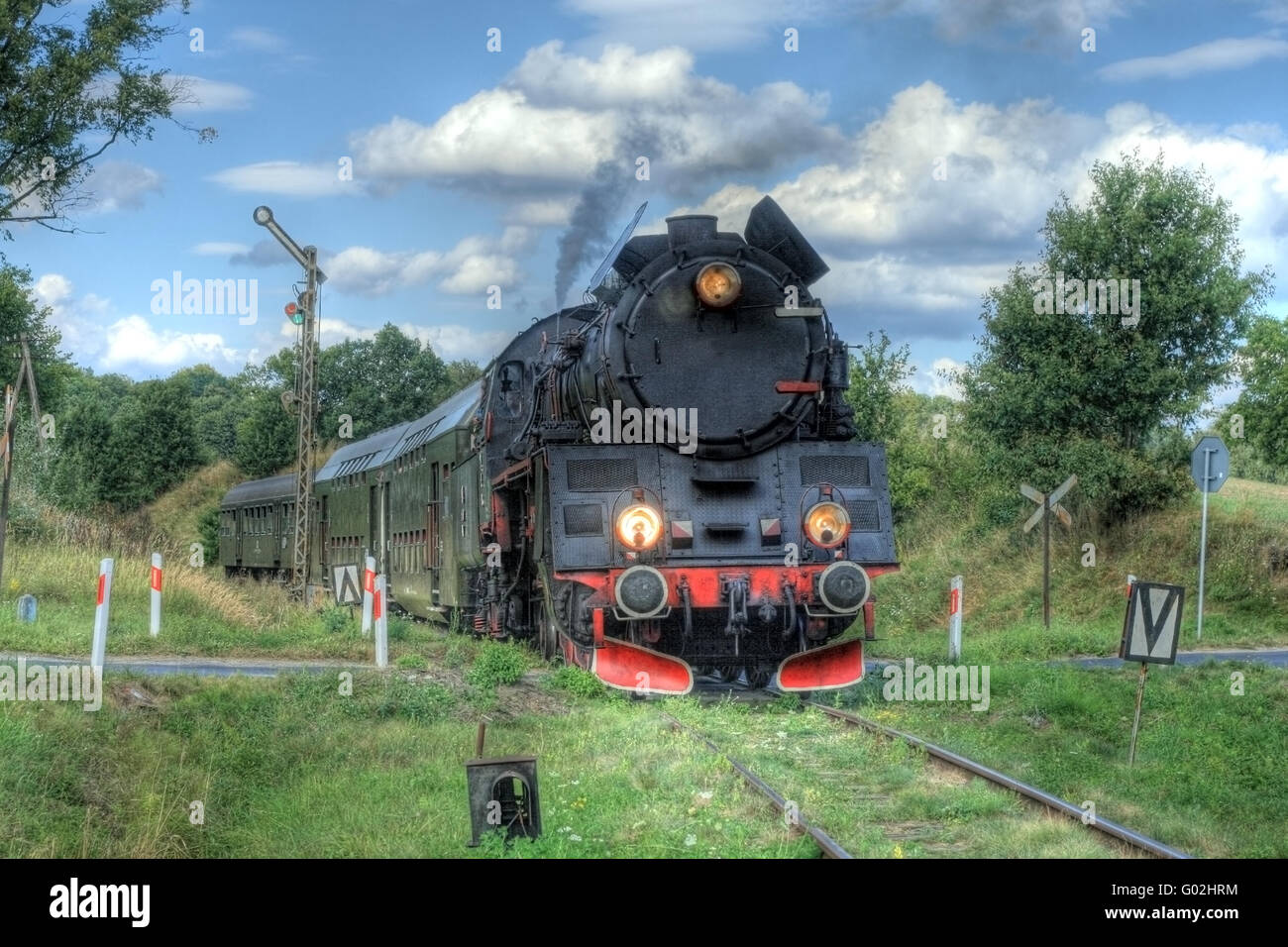 Old retro steam train passing through polish countryside Stock Photo ...