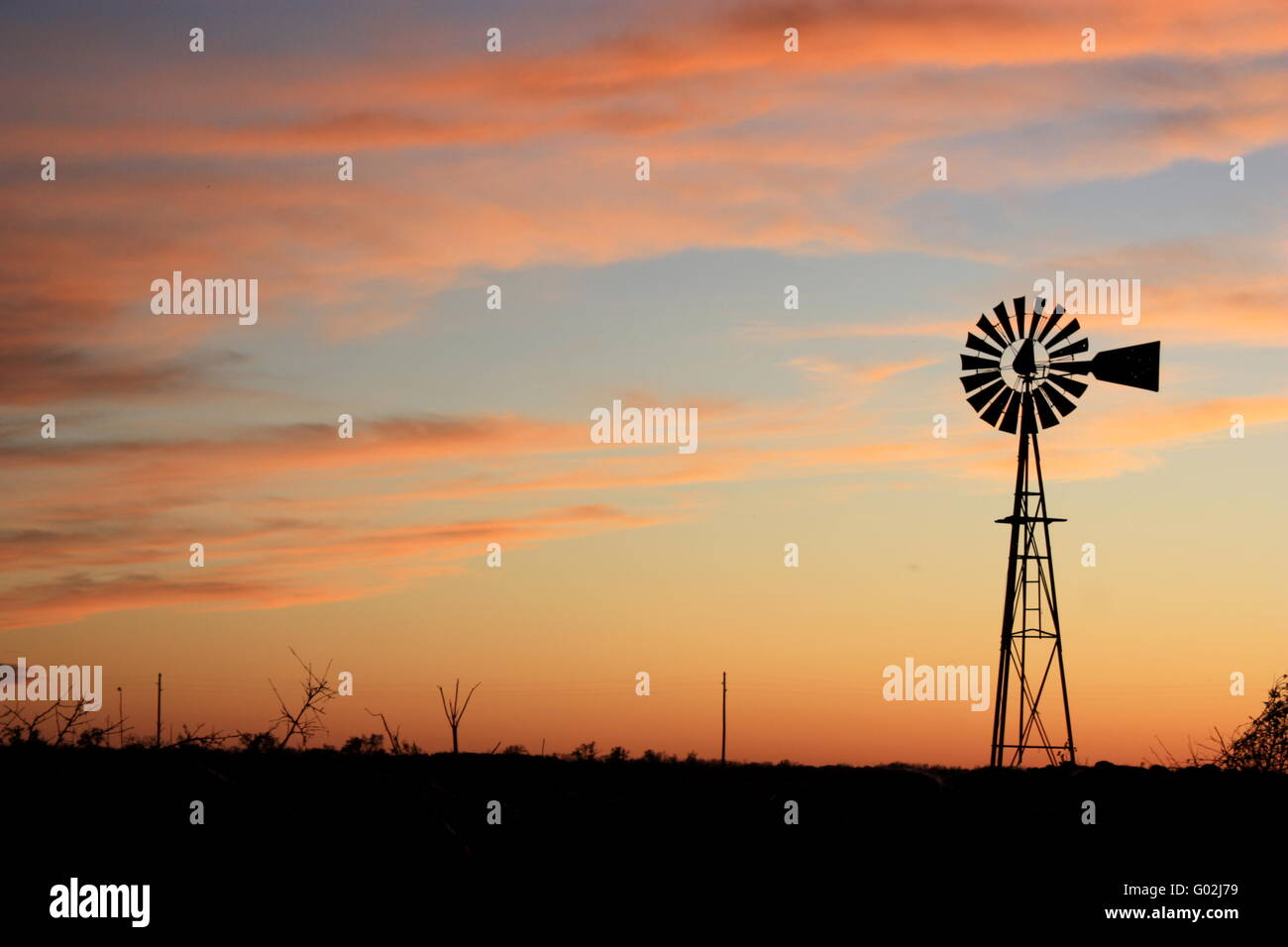 Bright Kansas sunset windmill Stock Photo - Alamy