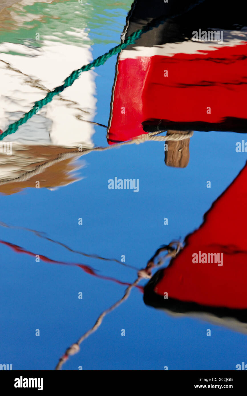 Reflections of boats in the harbour Stock Photo - Alamy