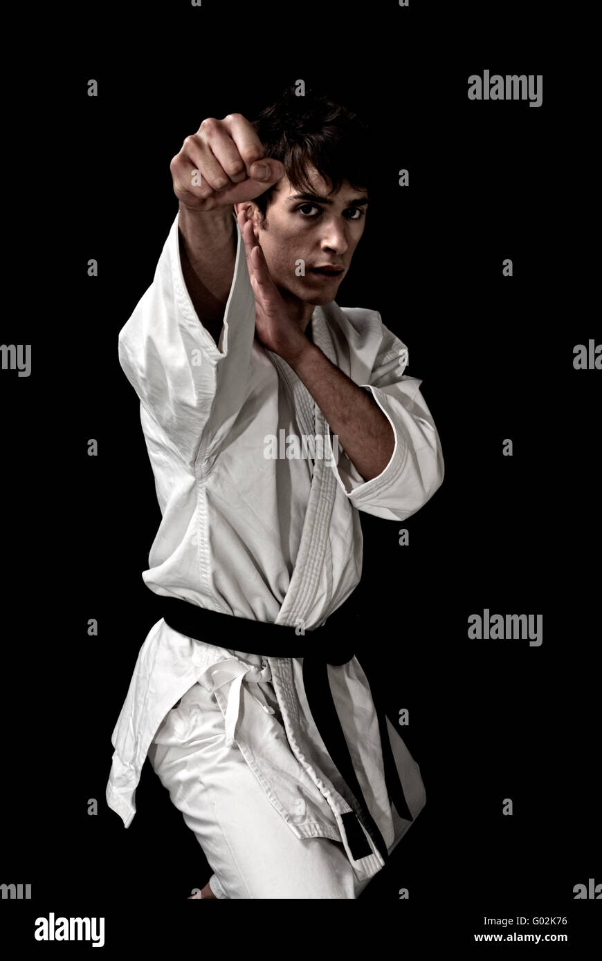 High Contrast karate young male fighter on black background Stock Photo ...