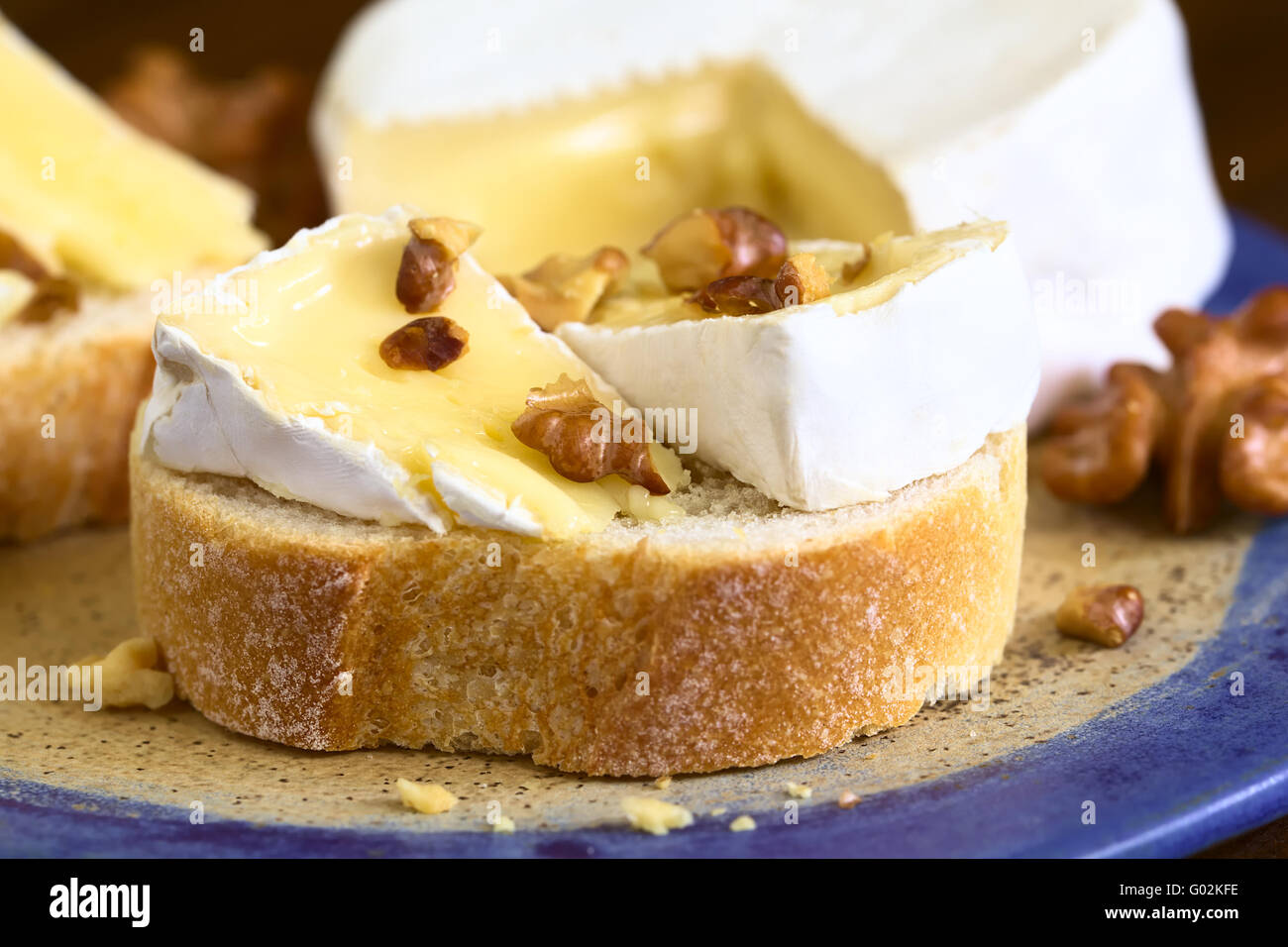 Baguette with camembert cheese and walnuts, photographed with natural ...