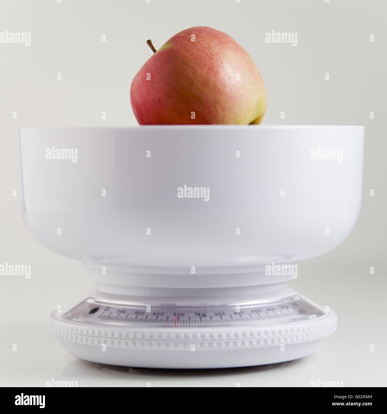 apple in a kitchen scale Stock Photo - Alamy