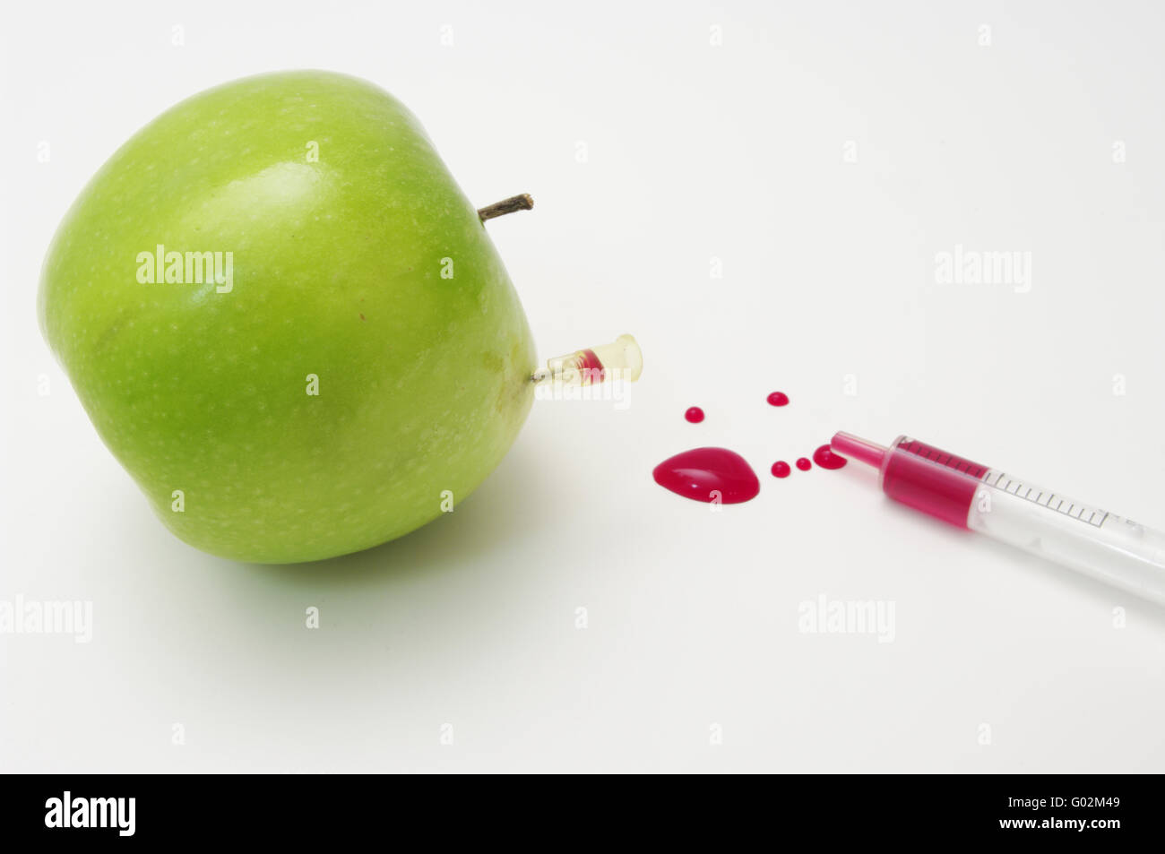 Blood drawn out of green apple Stock Photo - Alamy