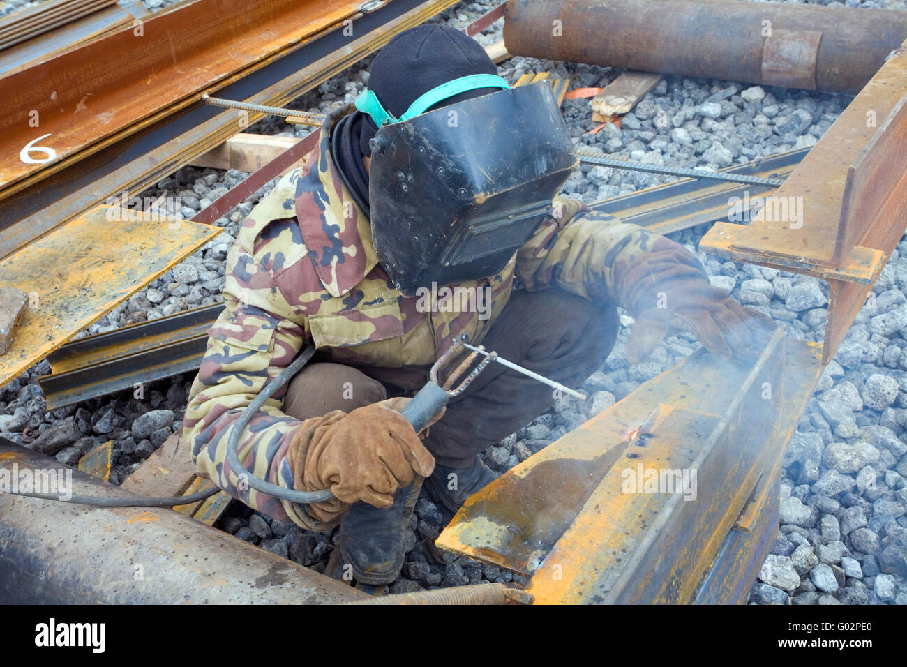 Welder in protective mask welding metal construction on open air Stock ...