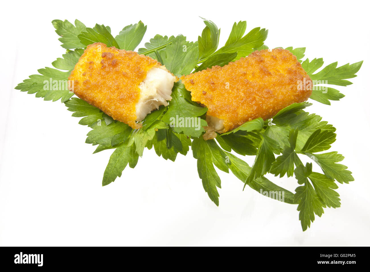 Broken fish stick isolated on white with some parsley Stock Photo - Alamy