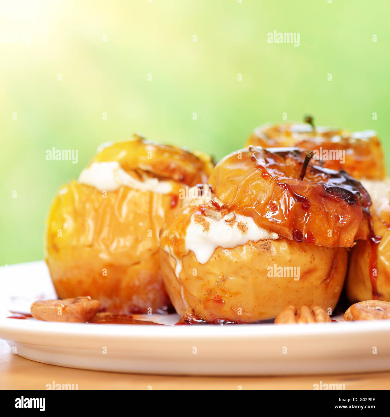 Closeup photo of a tasty baked apples stuffed with cream honey and nuts ...