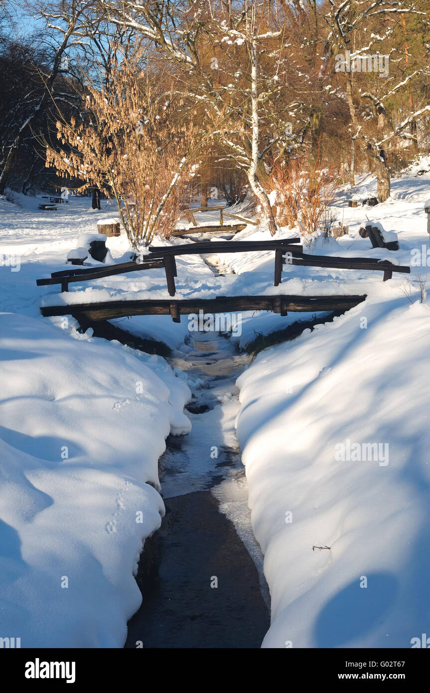 Wooden bridge and brook Stock Photo - Alamy