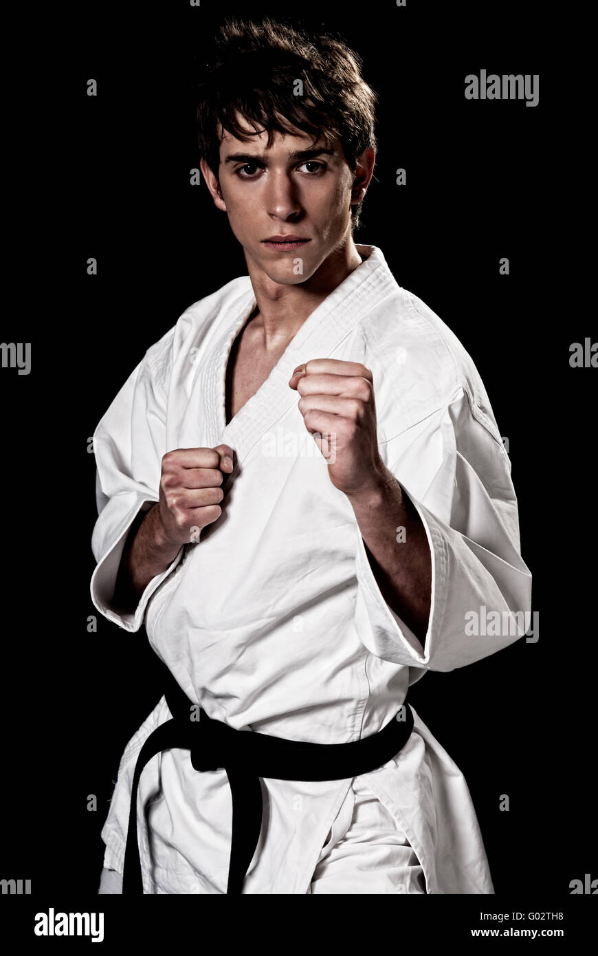 Karate male fighter young high contrast on black background Stock Photo ...