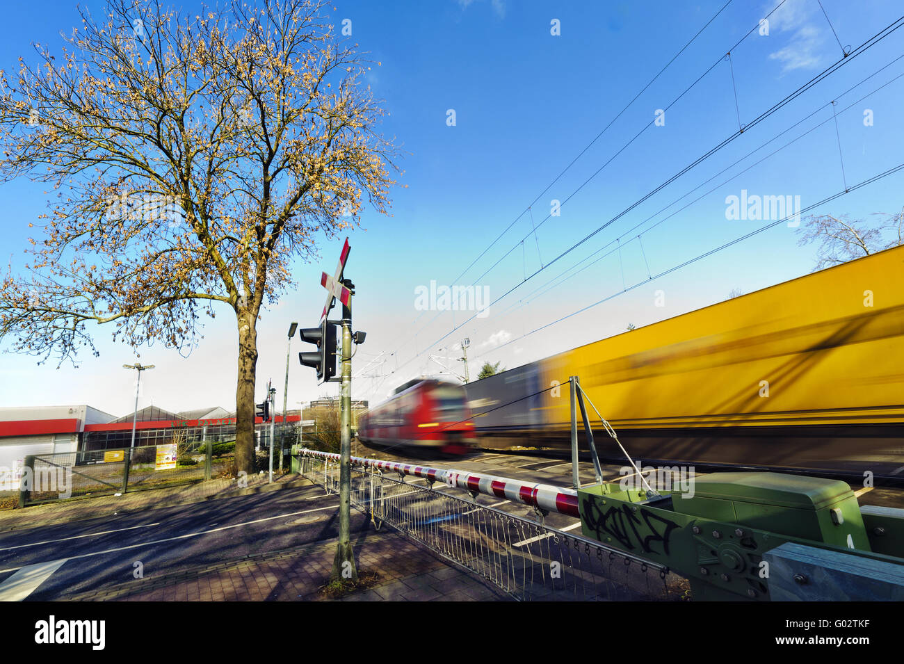 Passenger and freight train meet at a railway cros Stock Photo - Alamy