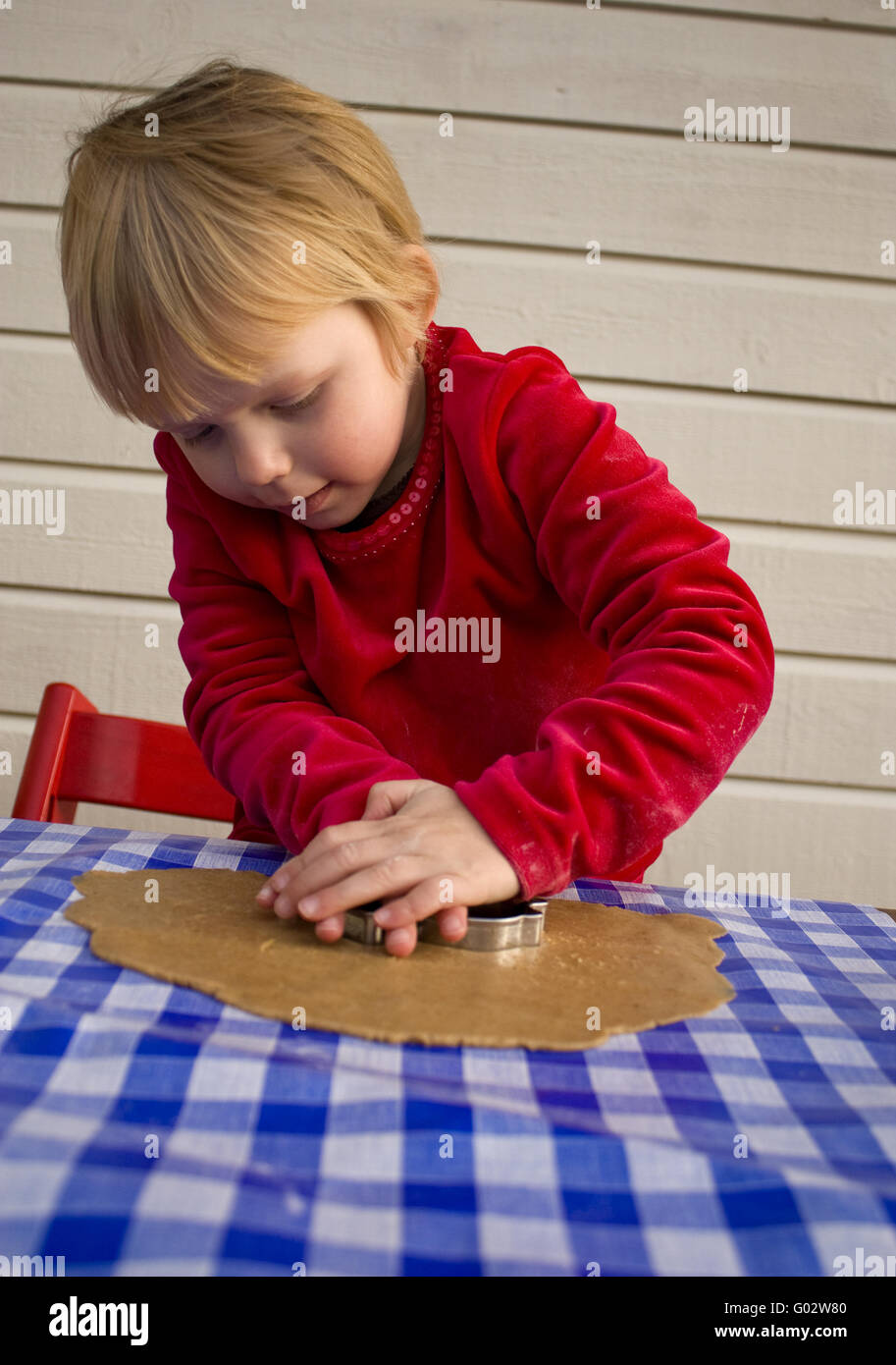 Child making gingerbread cookies Stock Photo - Alamy