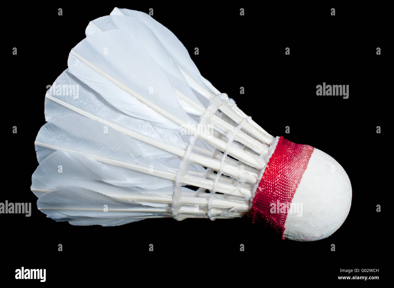 Single white shuttlecock against the black background Stock Photo - Alamy