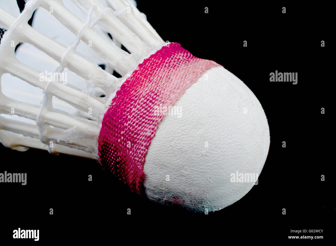 Single white shuttlecock against the black background Stock Photo - Alamy