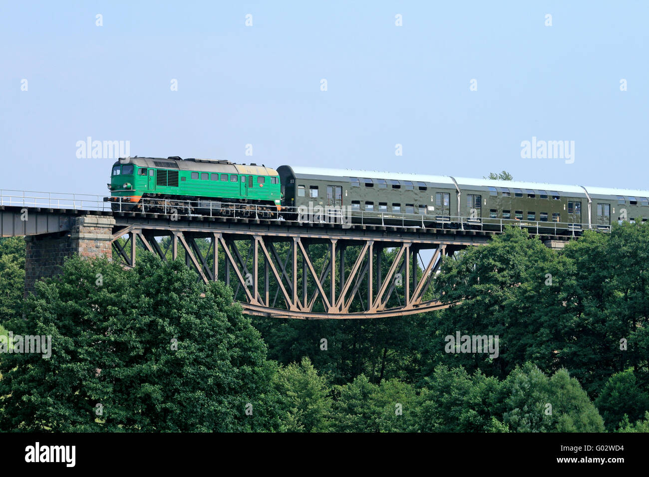 Passenger train passing through the big steel bridge Stock Photo - Alamy