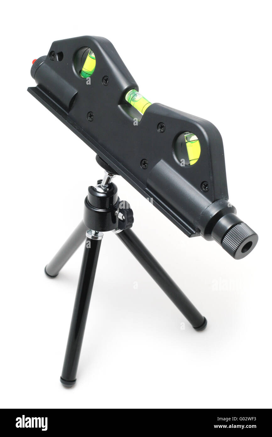 Laser level tool on a tiny tripod isolated over white background Stock ...