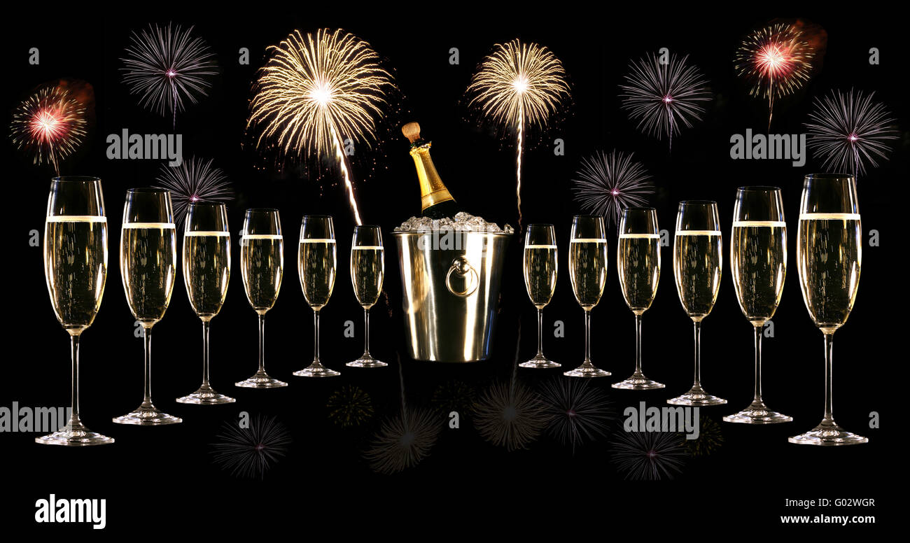 Glasses of champagne with silver ice bucket and fireworks Stock Photo ...