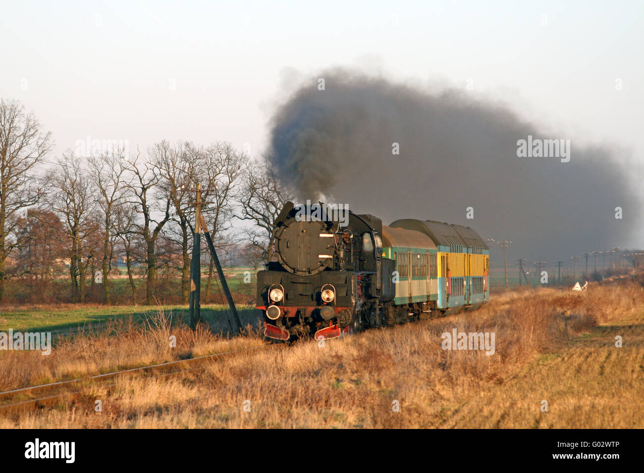Old retro steam train passing through countryside Stock Photo - Alamy