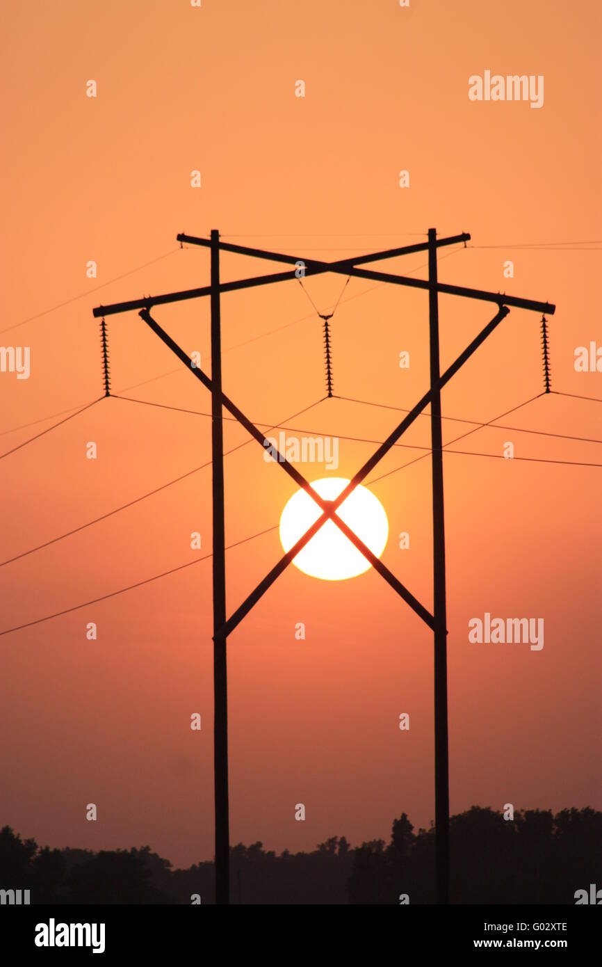 Orange Sunset with electrical wires and poles Stock Photo - Alamy