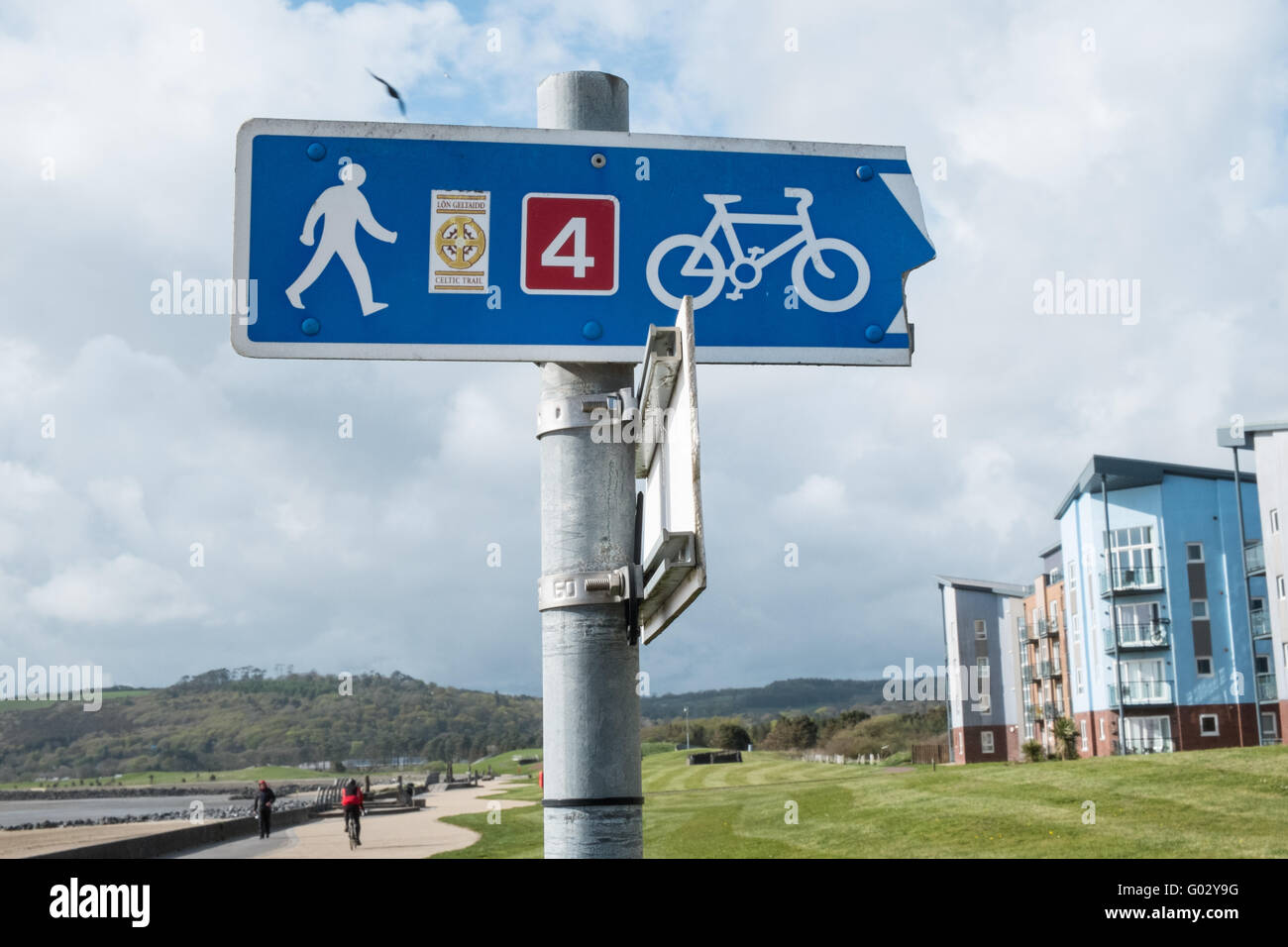 Cycle path route 4 sign and hiking on Millennium Coastal Path at ...