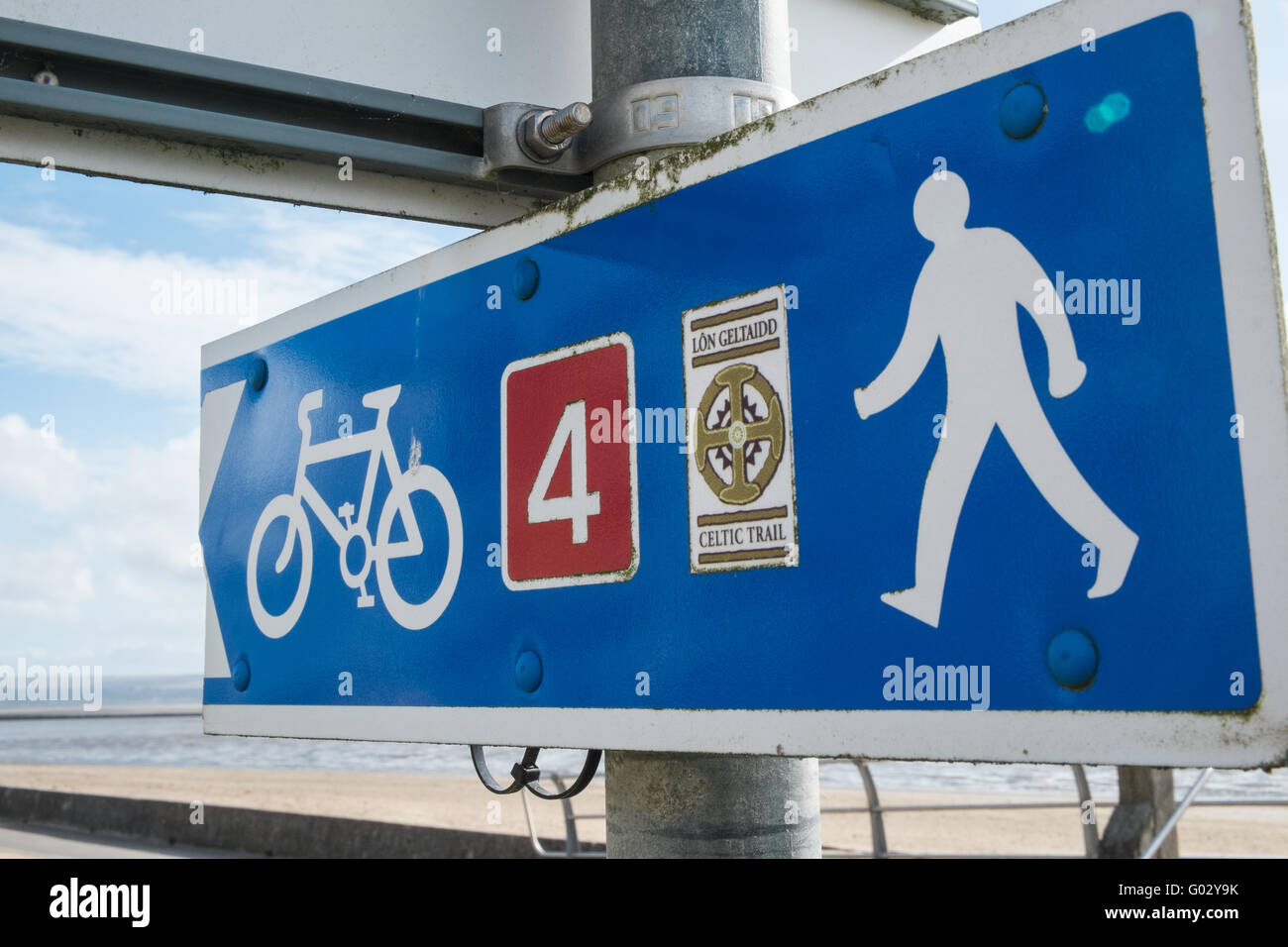 Cycle path route 4 sign and hiking on Millennium Coastal Path at ...