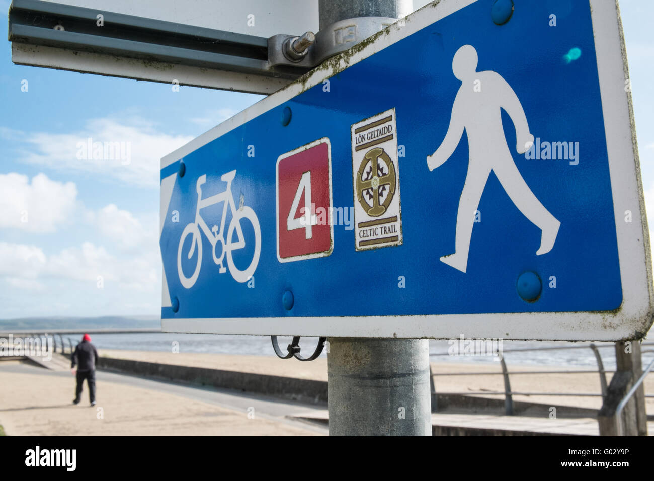 Cycle path route 4 sign and hiking on Millennium Coastal Path at ...