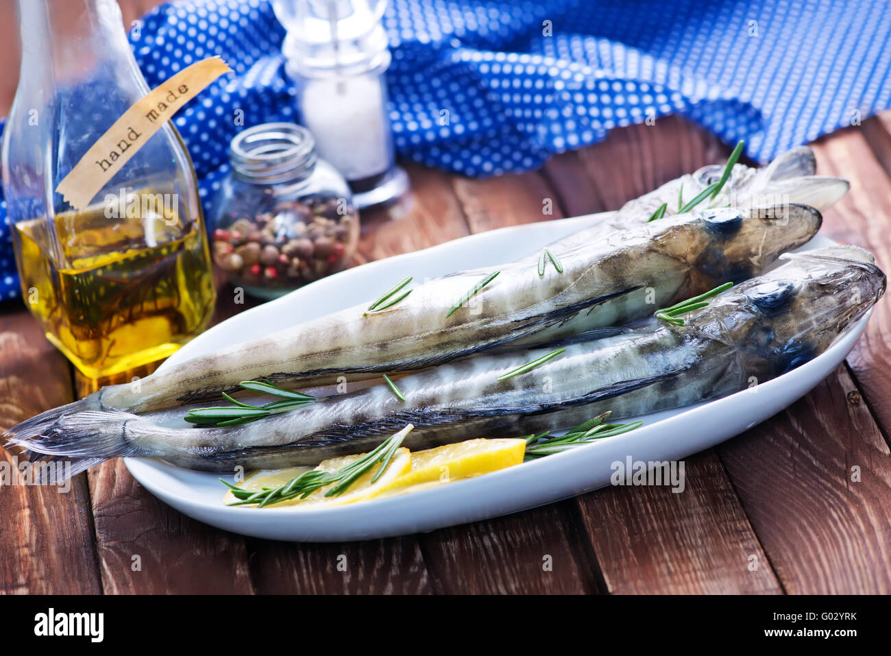 raw fish with salt and lemon on a table Stock Photo - Alamy