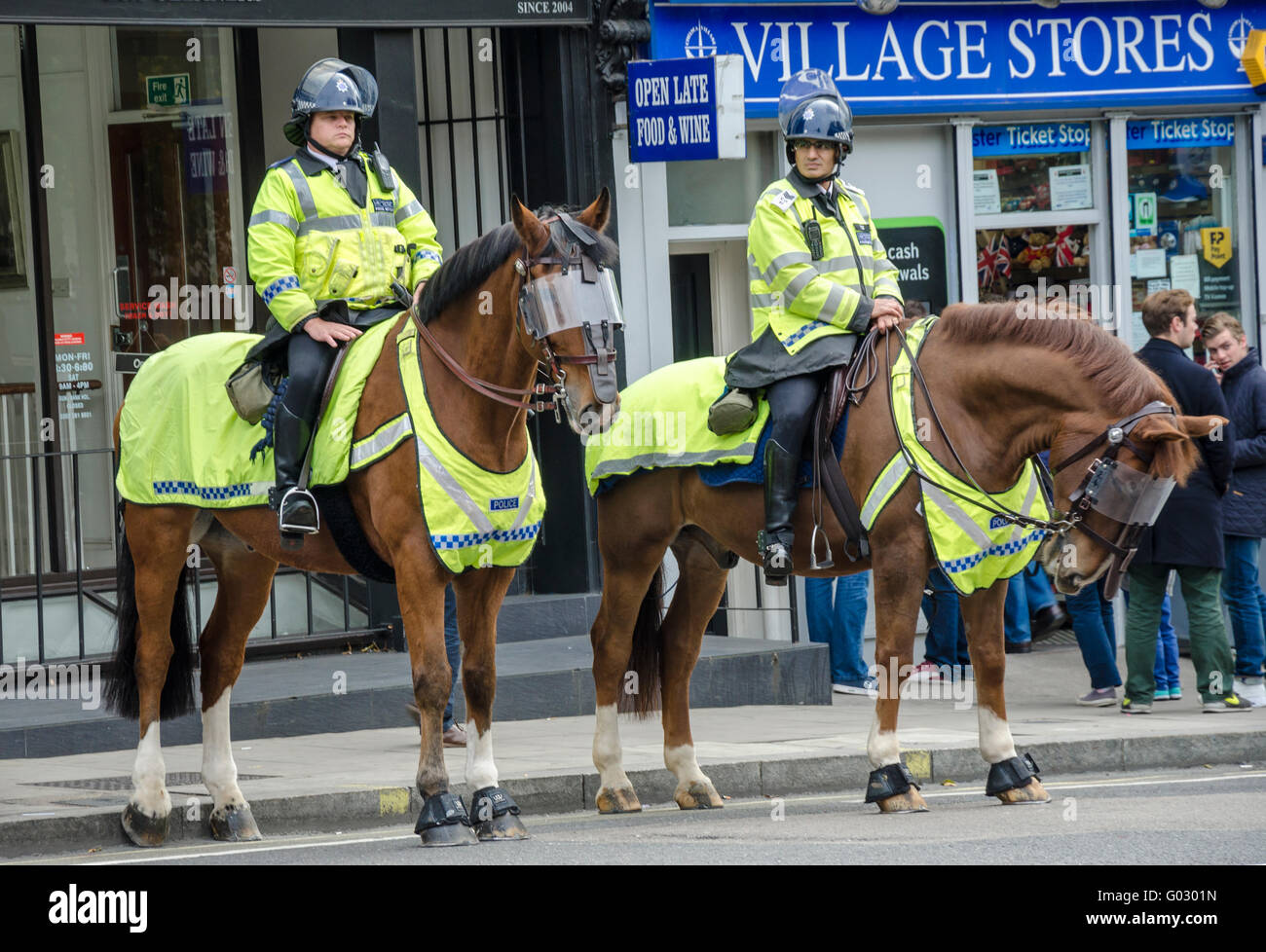 Mounted police officers watch over football supporters who are on their ...