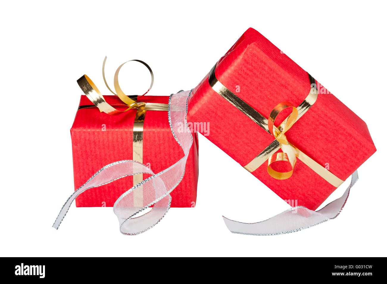 Two red and gold gift boxes with a flowing silver ribbon Stock Photo ...
