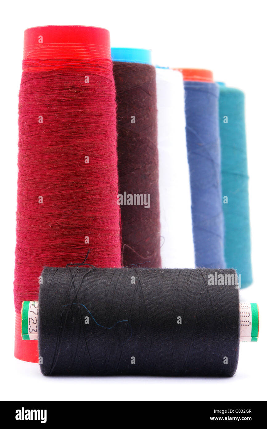 Spools of thread isolated over white background Stock Photo - Alamy