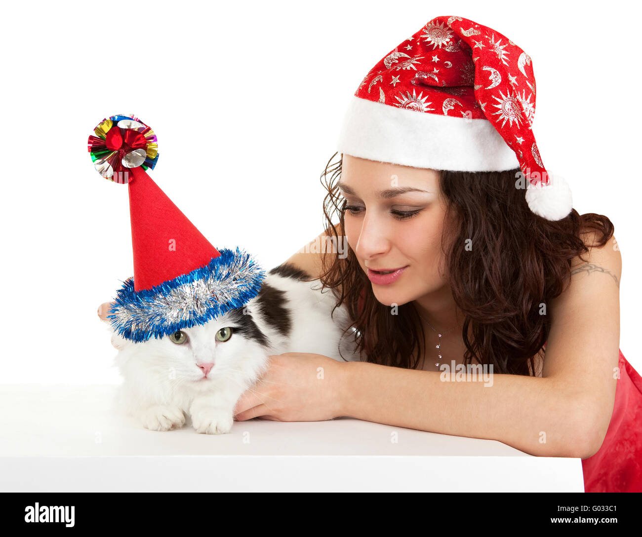 Beautiful girl with a cat in New Year's caps Stock Photo - Alamy