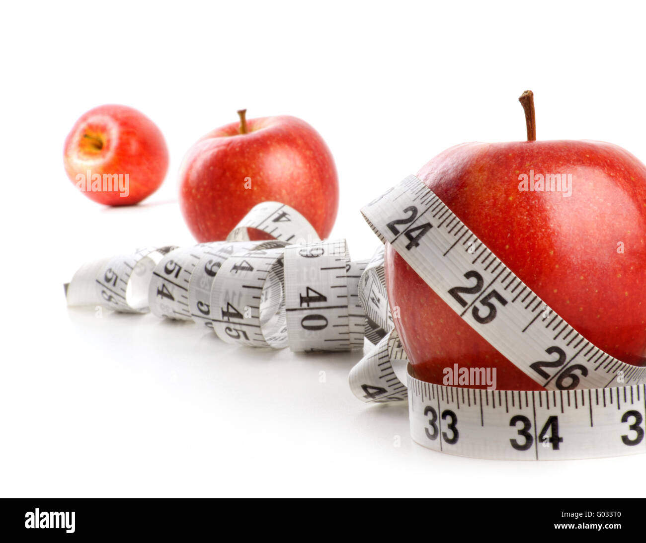 Red apples and measuring tape on white background Stock Photo - Alamy