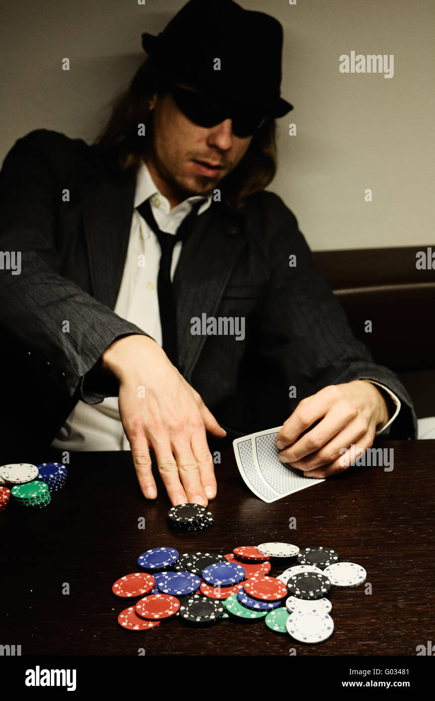 Man playing poker Stock Photo - Alamy