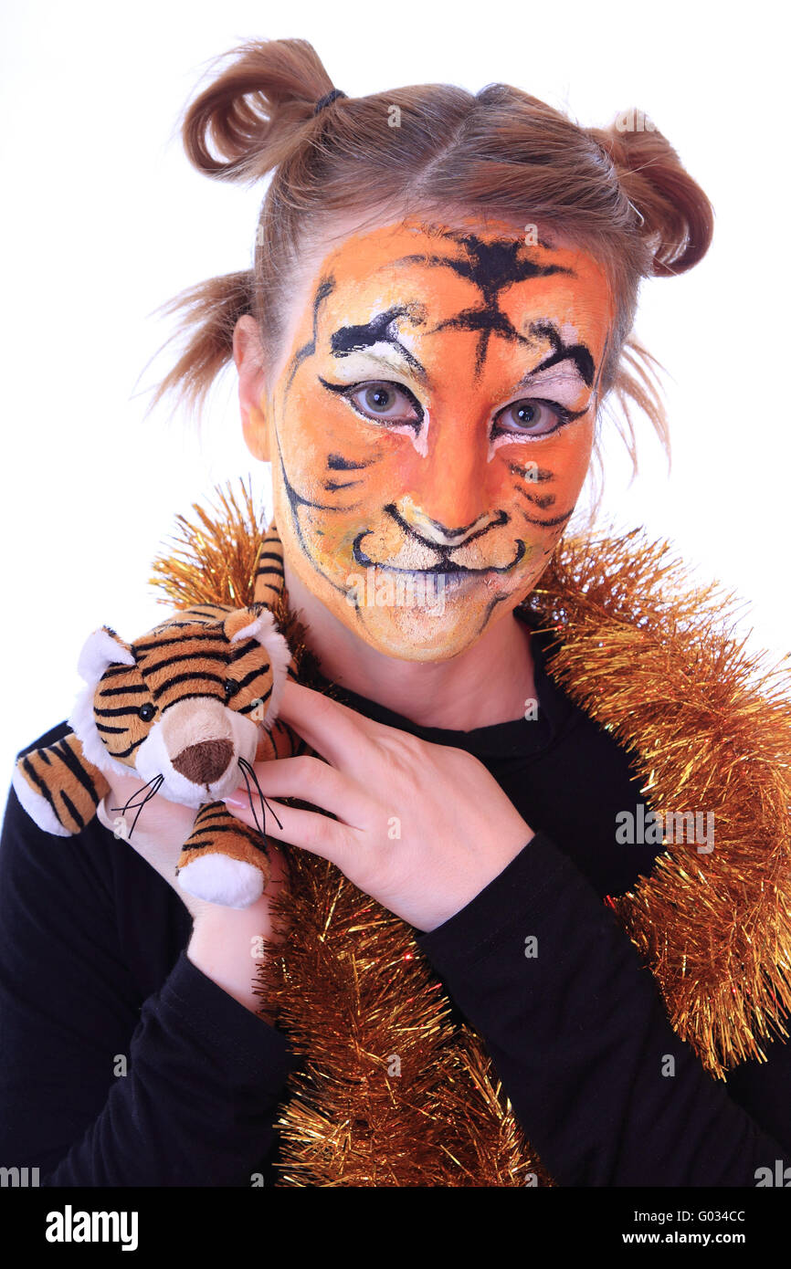 Girl in appearance a tiger with a toy tiger cub Stock Photo - Alamy
