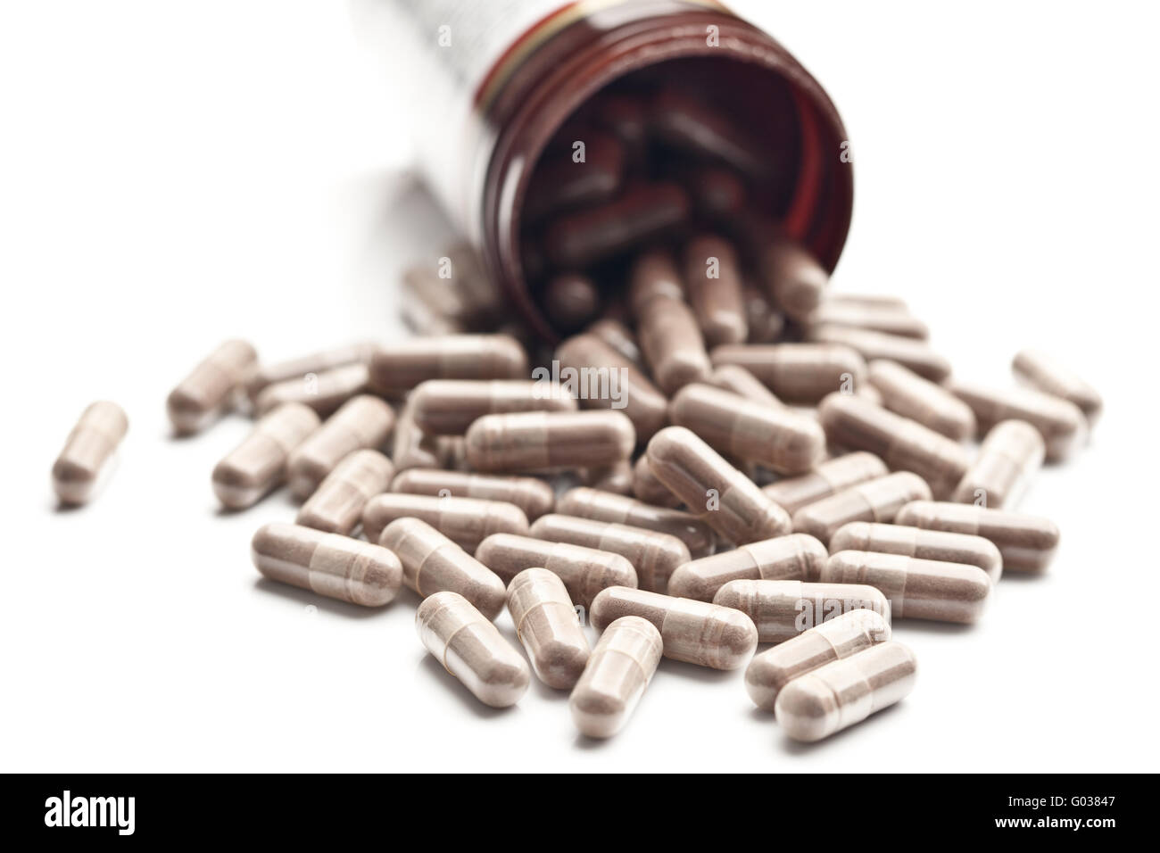 Medicinal pills poured out of the jar on a white background Stock Photo ...