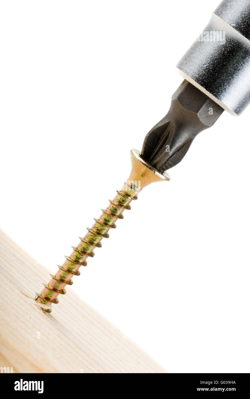 Closeup image of screwdriver and single screw in board on white ...