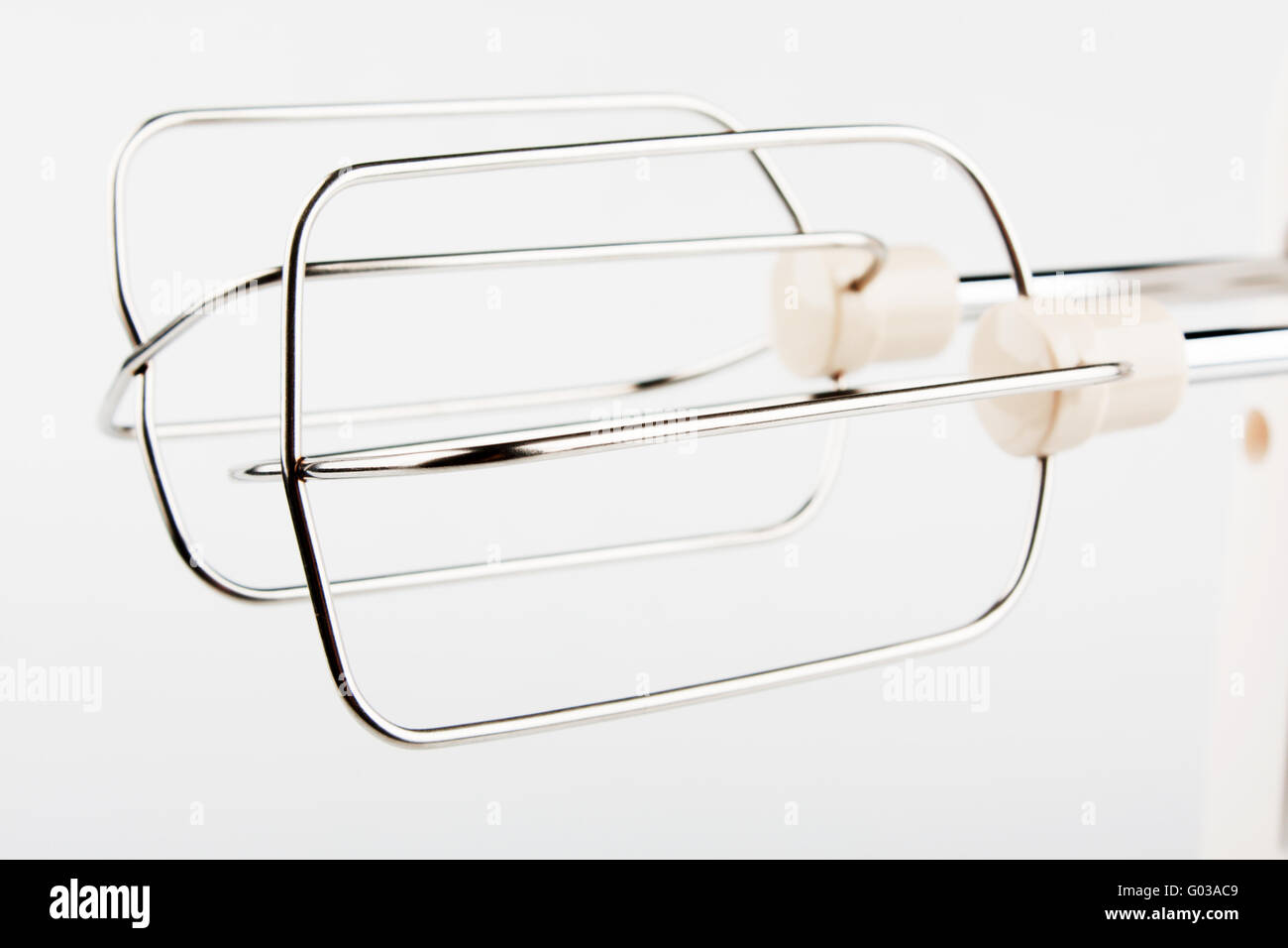 Details of mixer - metal beaters on white table Stock Photo - Alamy