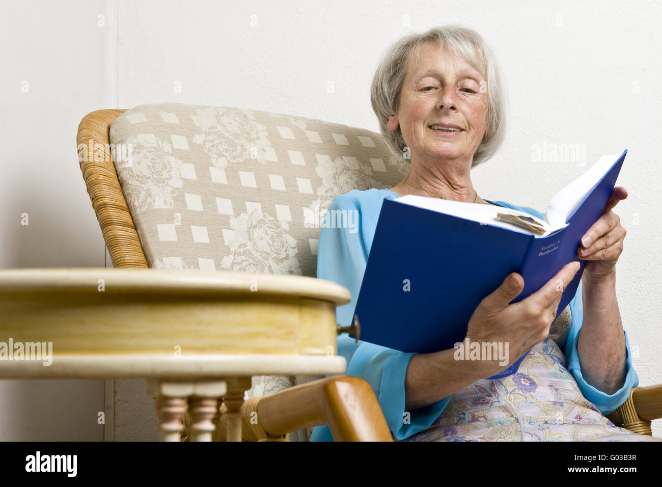 Senior woman reading a book Stock Photo - Alamy