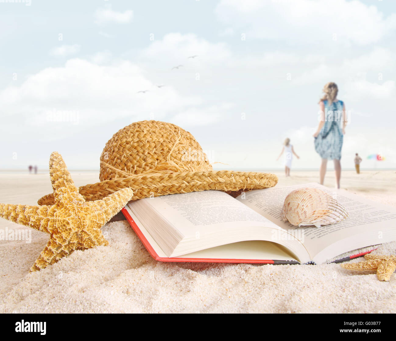 Straw hat , book and seashells on the beach Stock Photo - Alamy